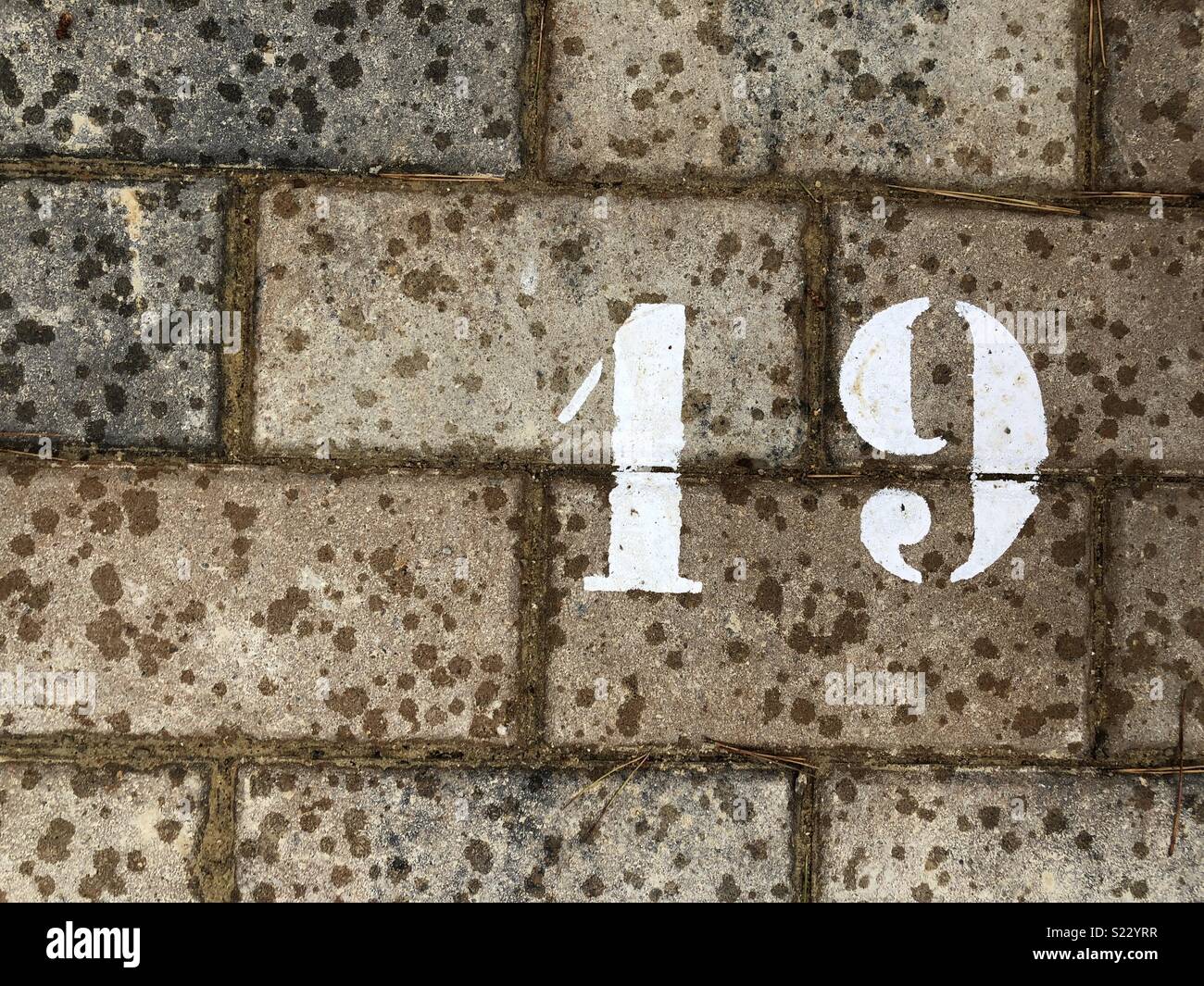 Number Nineteen written In white type on the pavement Stock Photo - Alamy