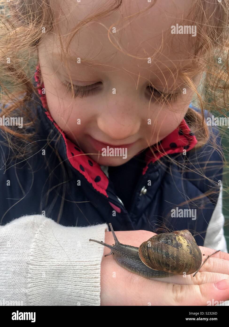 Girl with snail Stock Photo - Alamy