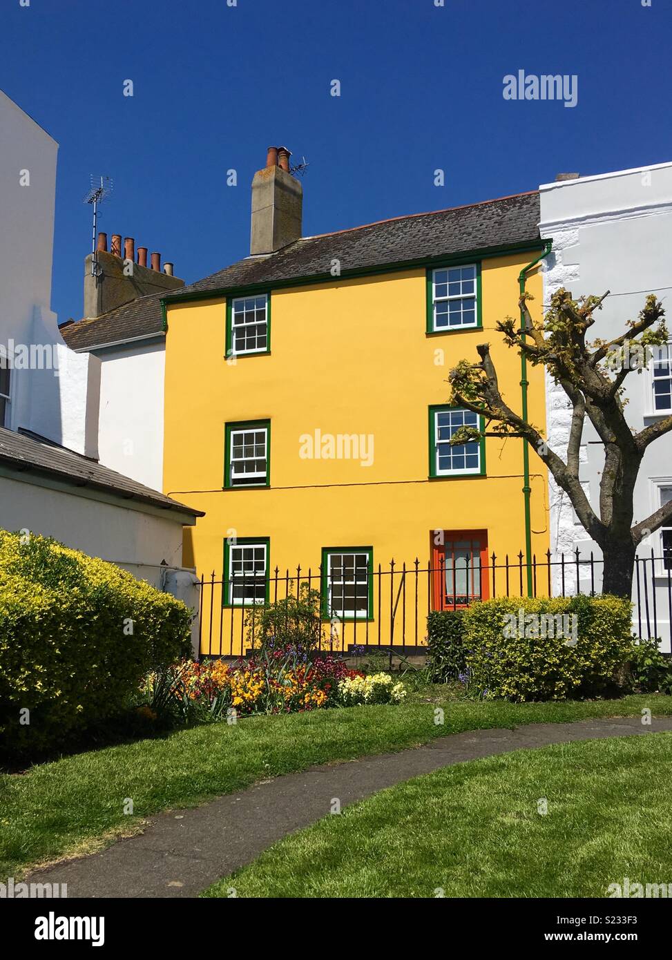 Yellow cottage in the sunlight Stock Photo - Alamy