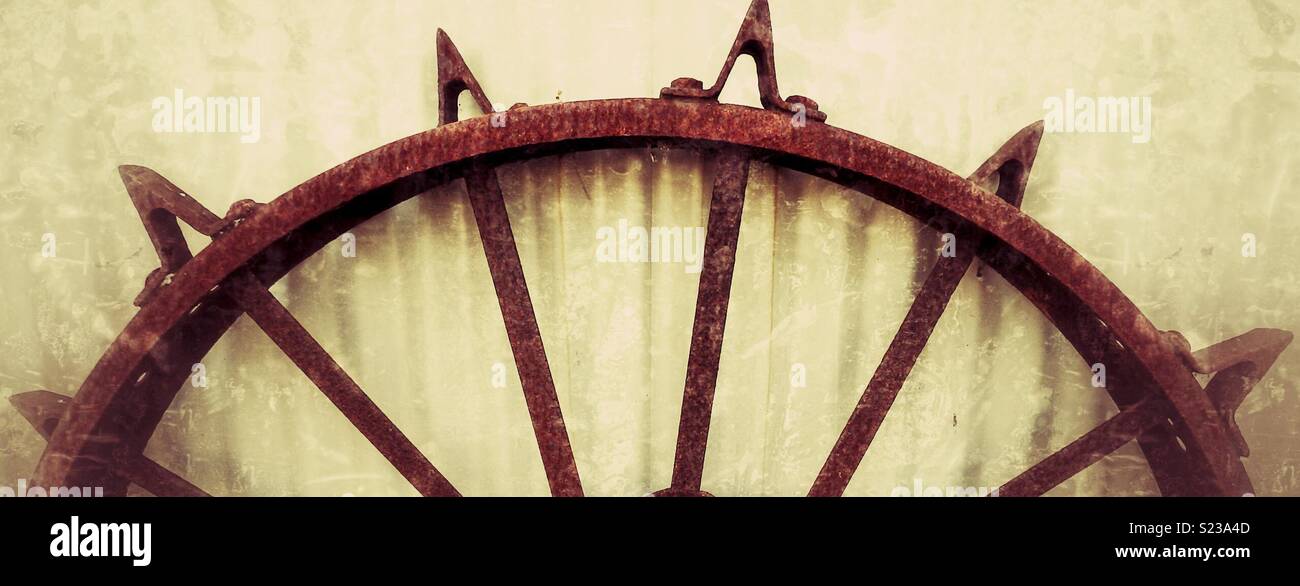 Top half of an old rusty cart wheel Stock Photo - Alamy