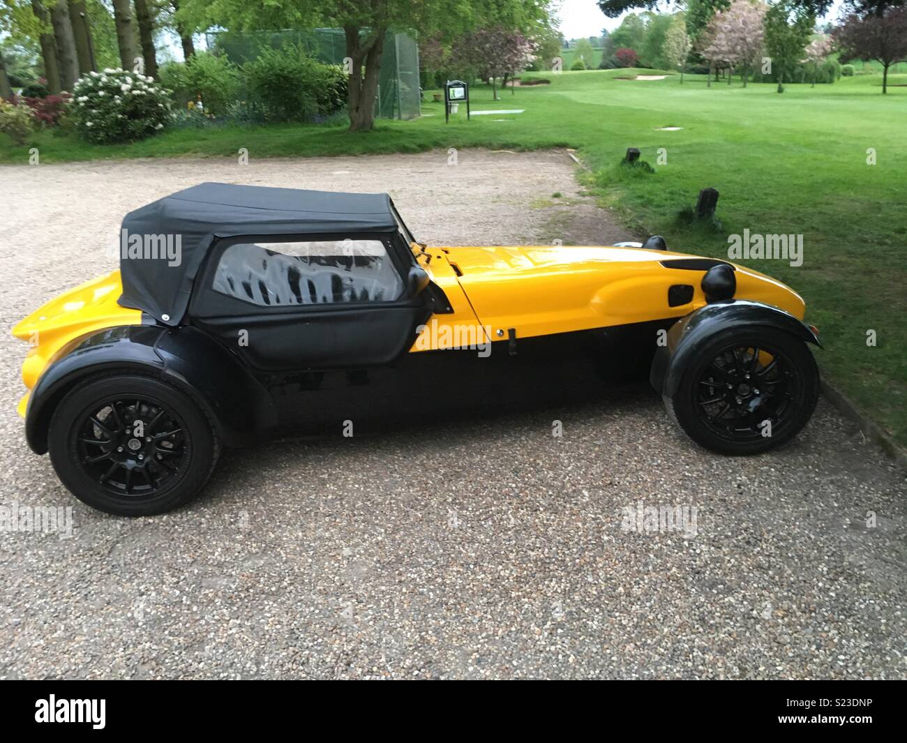 Yellow car at golf course Stock Photo - Alamy