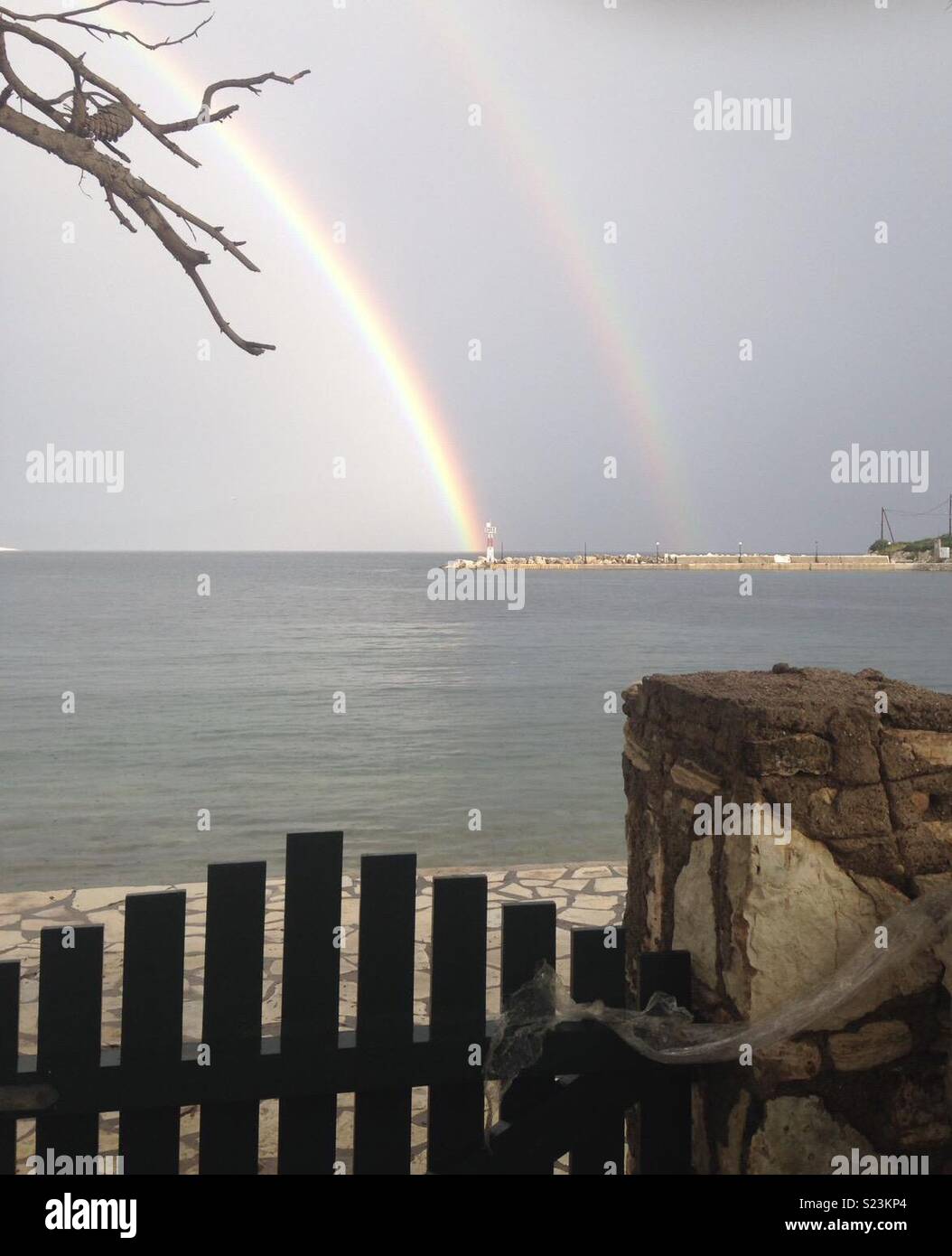 Double rainbow over the harbour and the sea Stock Photo - Alamy