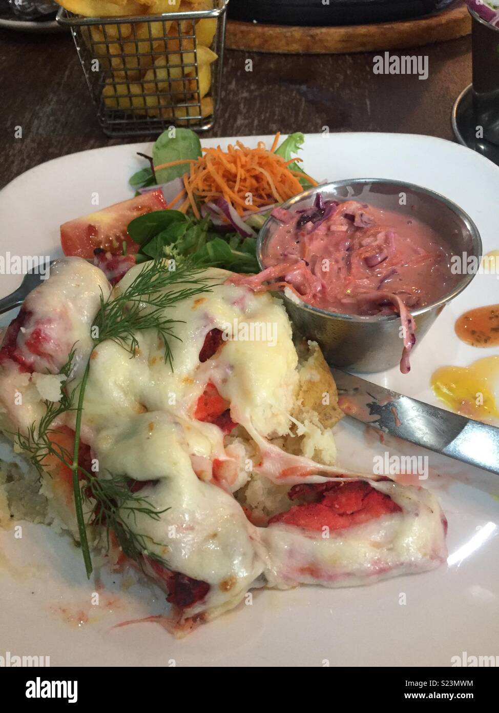 Chicken tikka melt jacket potato Stock Photo - Alamy