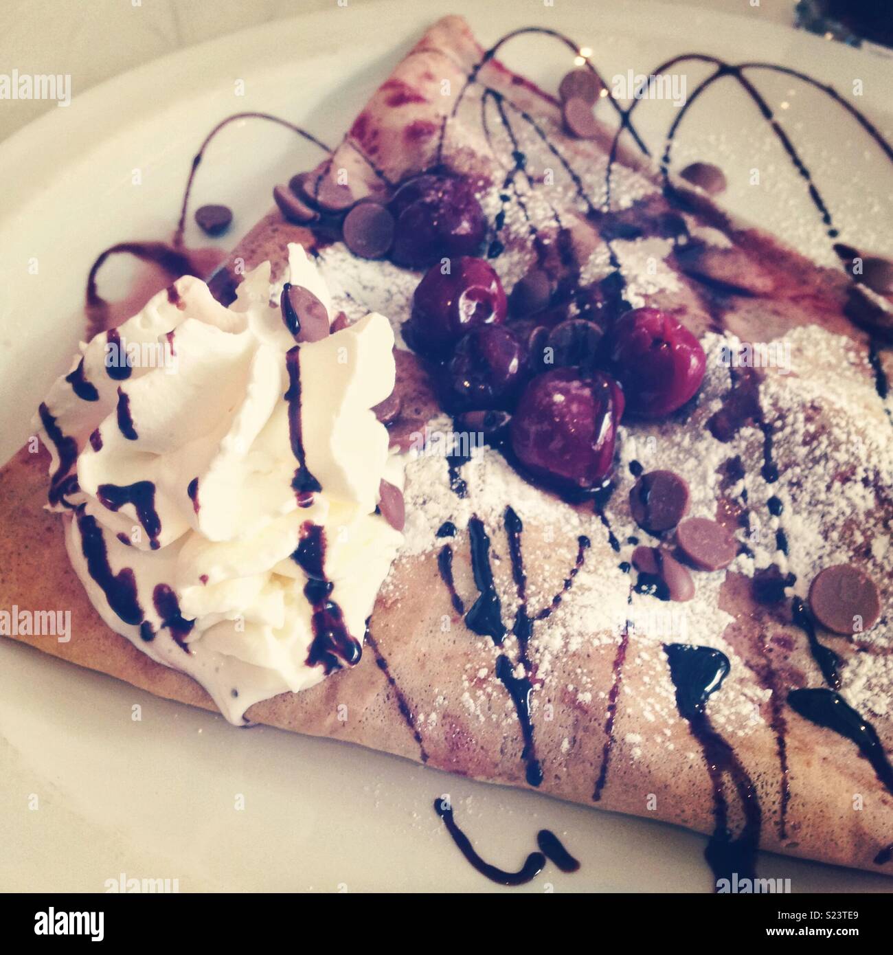 Folded crepe with chocolate, cherries and cream Stock Photo - Alamy