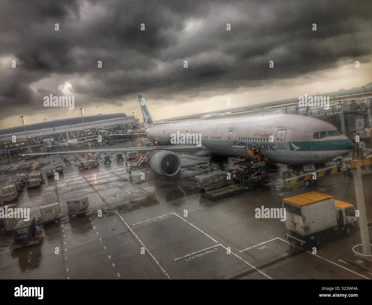 A Cathay Pacific Boeing 777 being loaded on the apron at Hong Kong ...