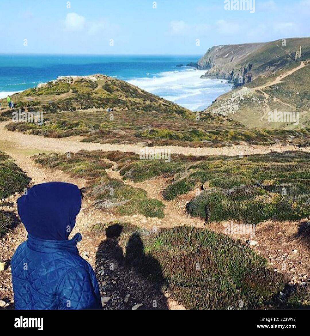 Child gazing across cliff to wheal Coates Stock Photo - Alamy