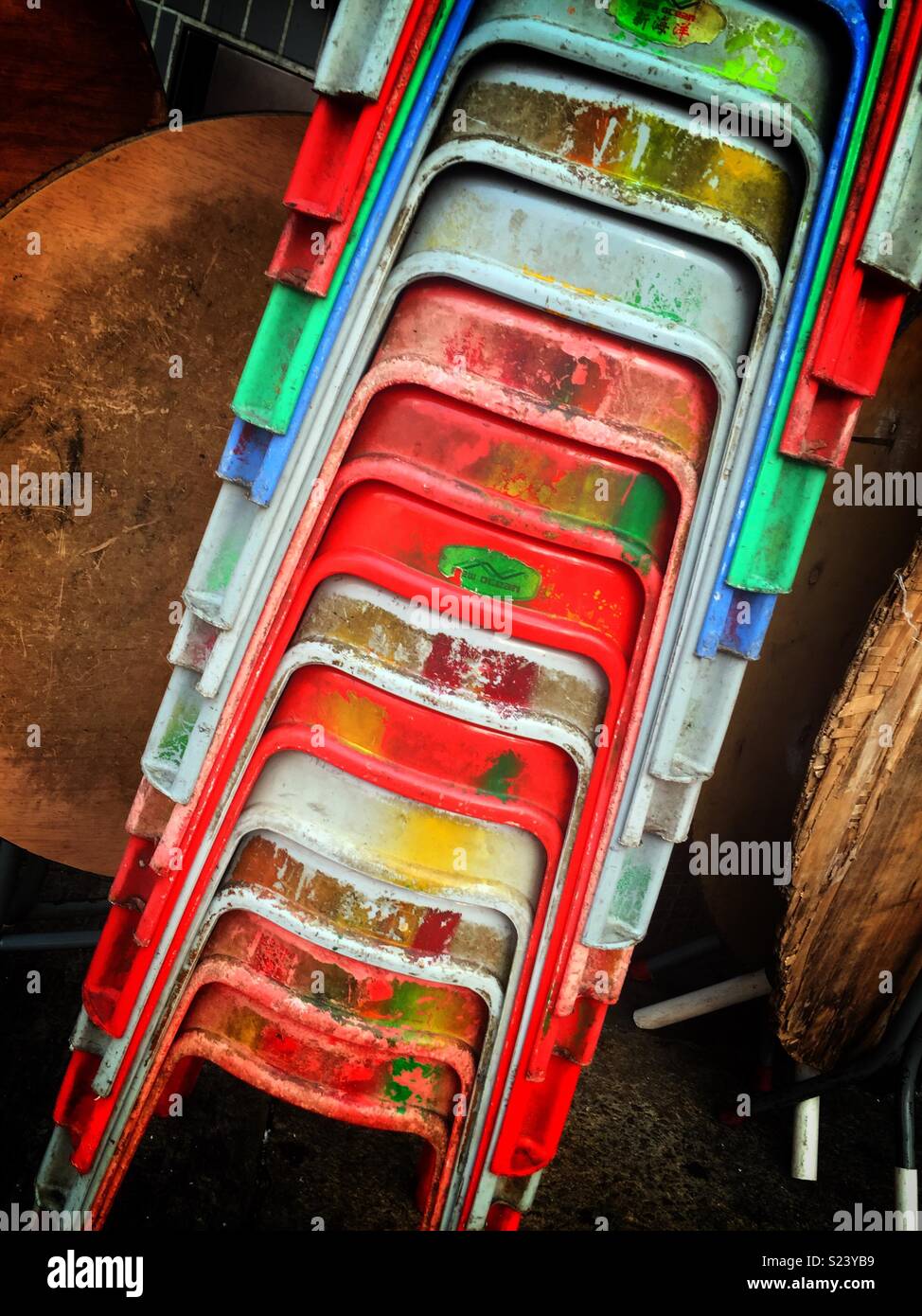 Coloured plastic stools in a street restaurant in Yuen Long, New ...