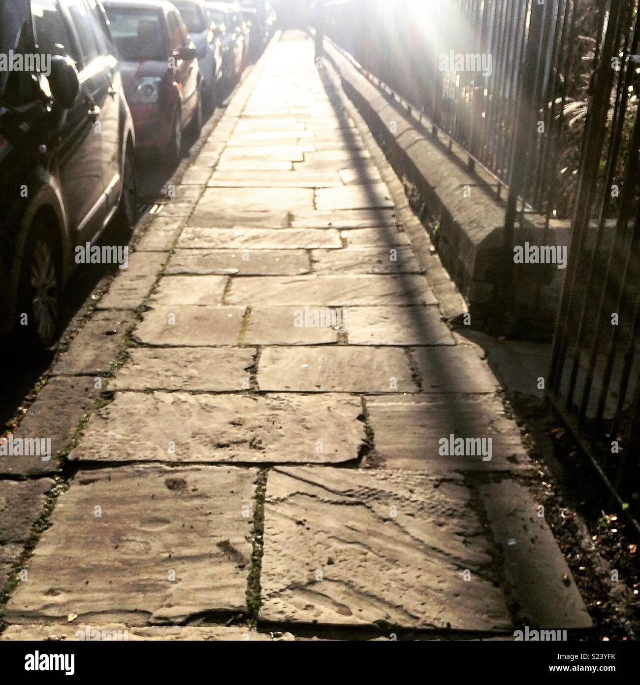 Beams of sunlight on a stone flag pavement Stock Photo - Alamy