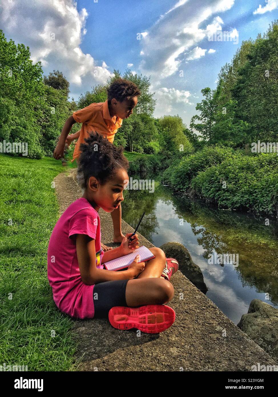 Children playing beside a stream Stock Photo - Alamy