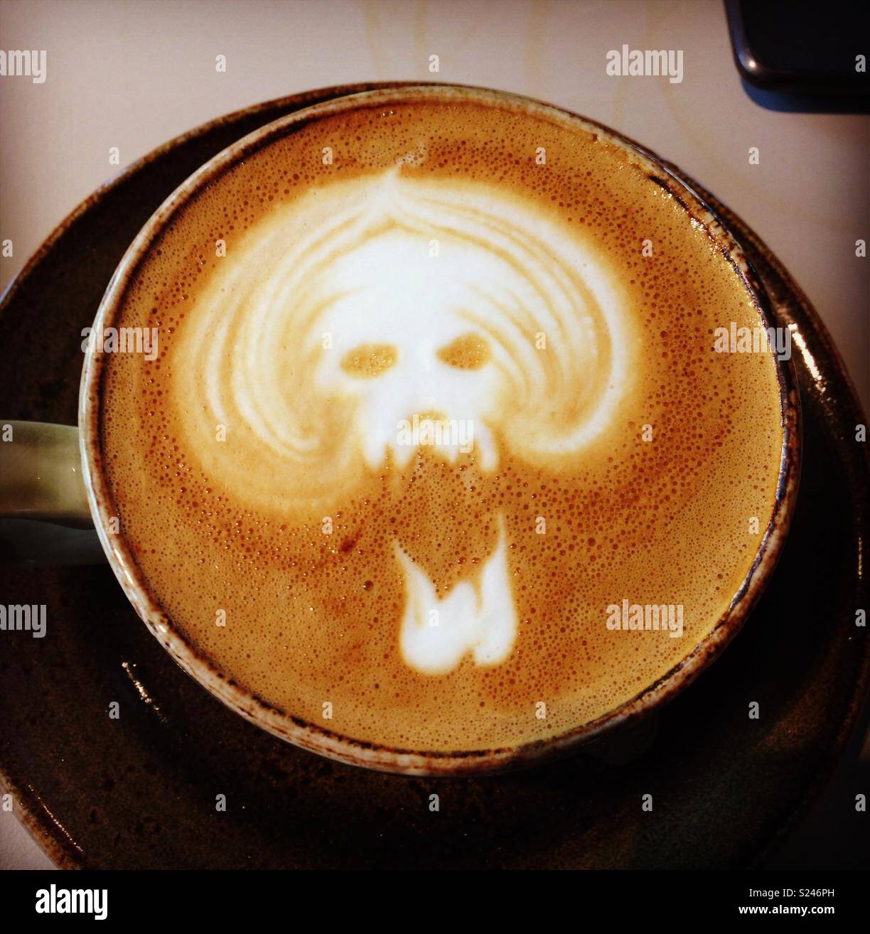 Coffee with skull milk art Stock Photo - Alamy