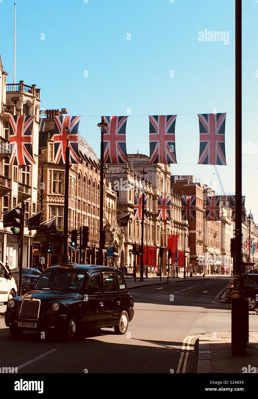 Piccadilly London with taxi and flags Stock Photo - Alamy