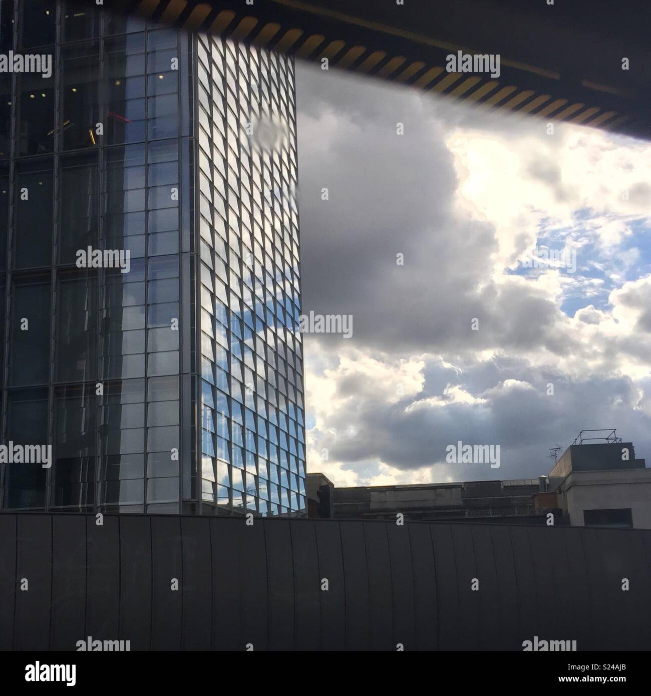 Dramatic clouds reflected on city building Stock Photo - Alamy
