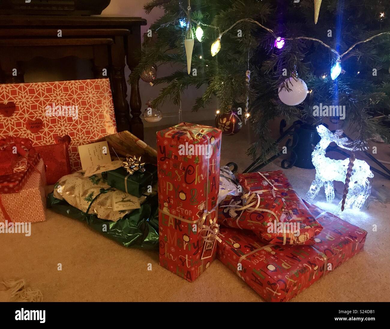 Christmas presents tree wrapped lights hi-res stock photography and ...