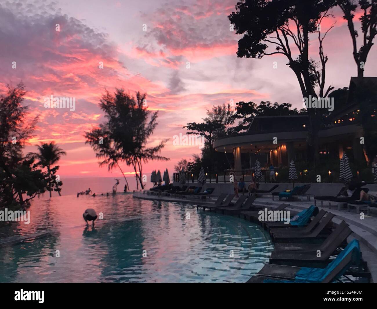 Beautiful sunset over view of infinity pool on beach side resort Stock ...