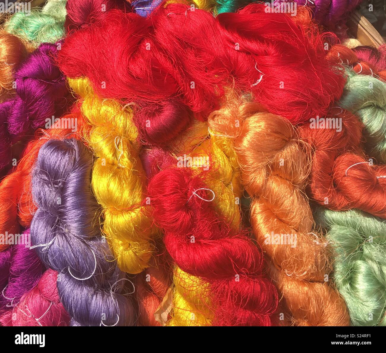 Rainbow colours captured in raw dyed silk, Thailand Stock Photo - Alamy