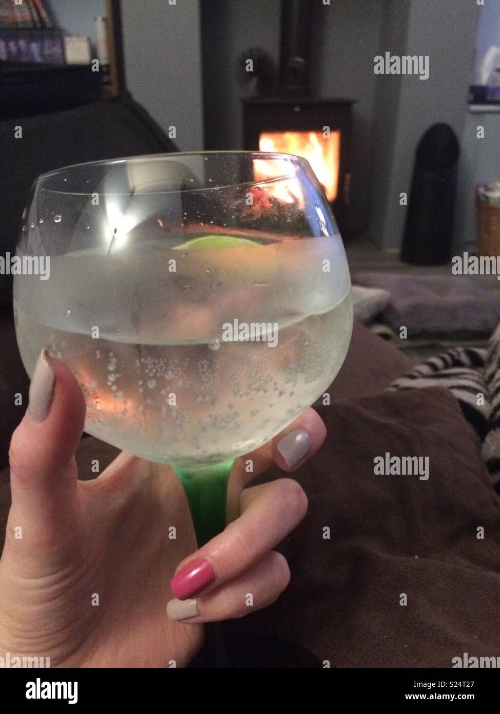 Drinking gin by the fire Stock Photo - Alamy