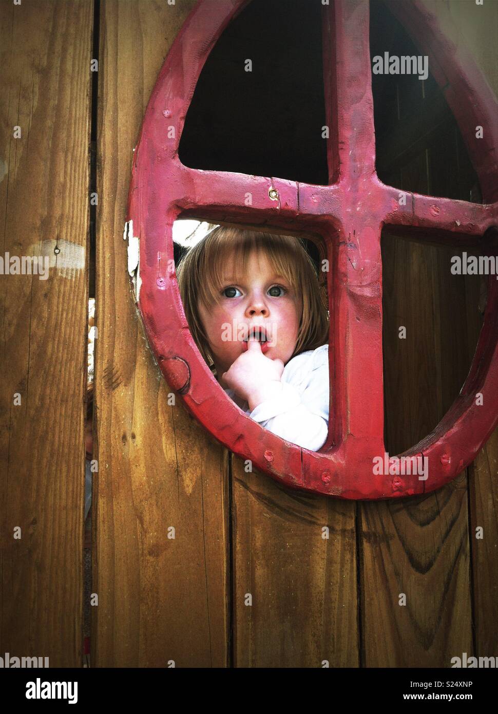 Child looking through window Stock Photo - Alamy