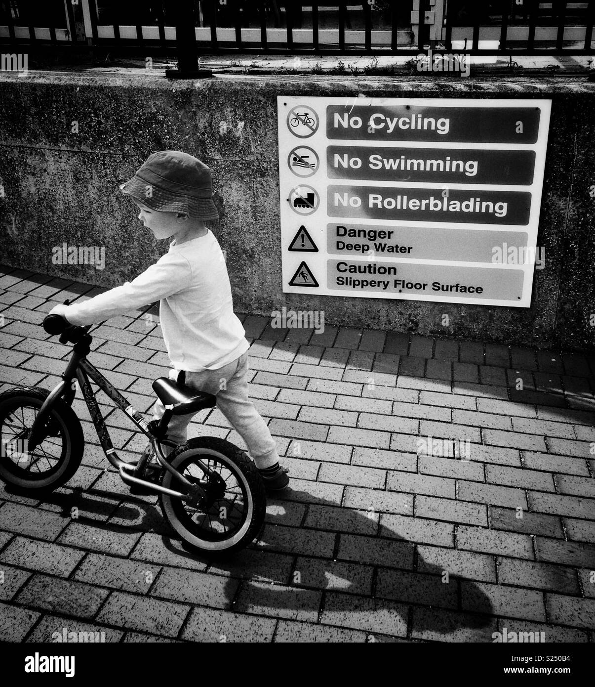 Boy pushing bike hi-res stock photography and images - Alamy