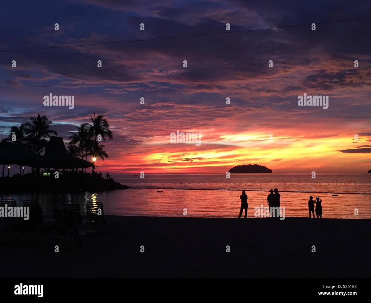 Beach sunset with people Stock Photo - Alamy