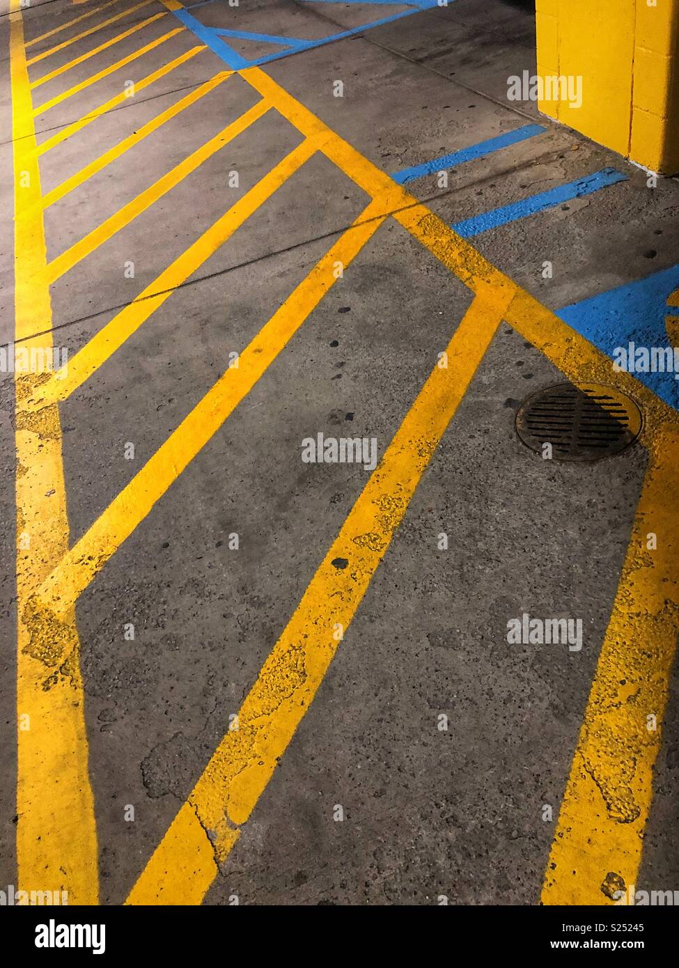 Yellow and blue lines painted on the floor in a parking garage Stock ...