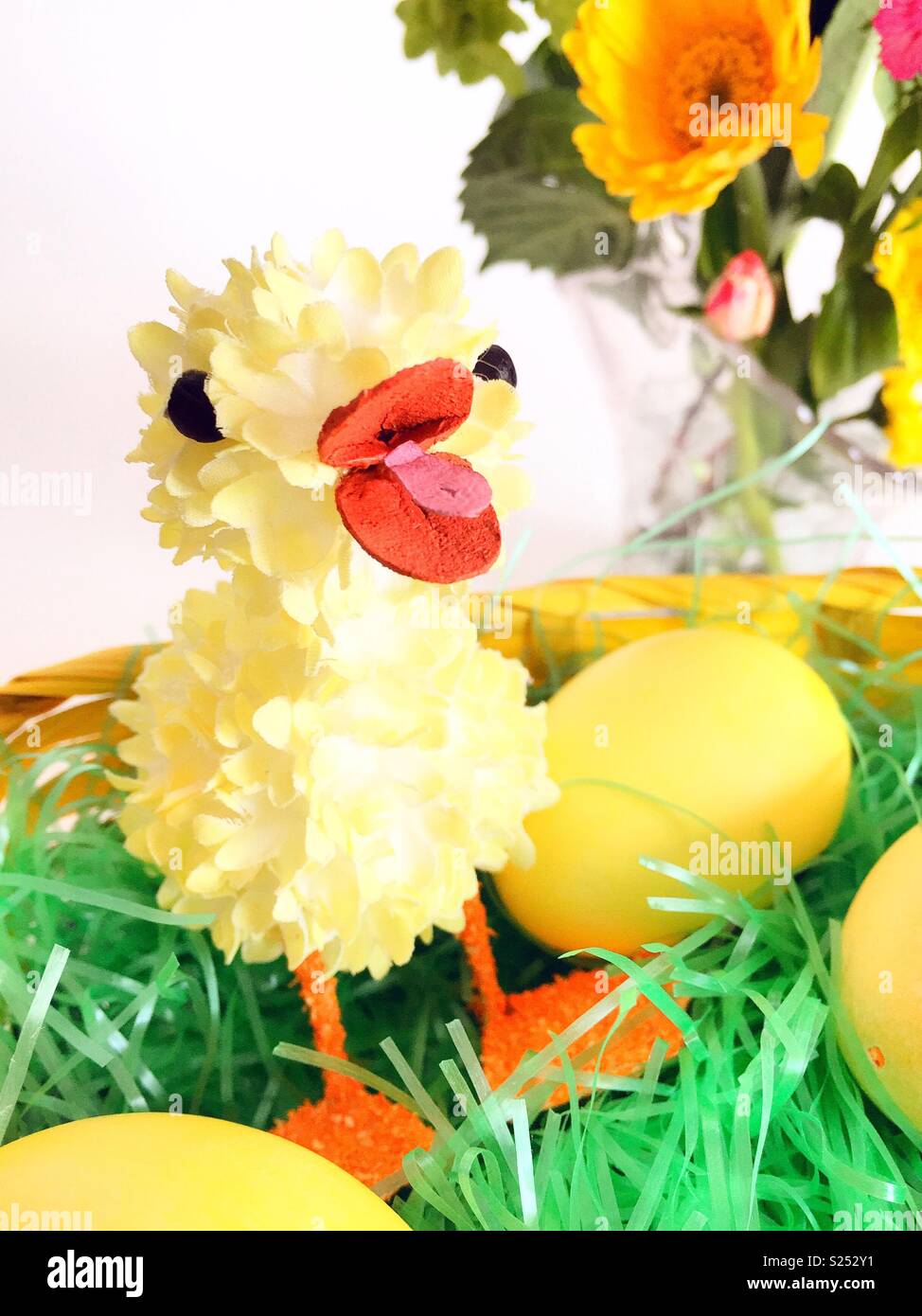 Easter still life featuring paper duckling and Easter eggs in an Easter ...