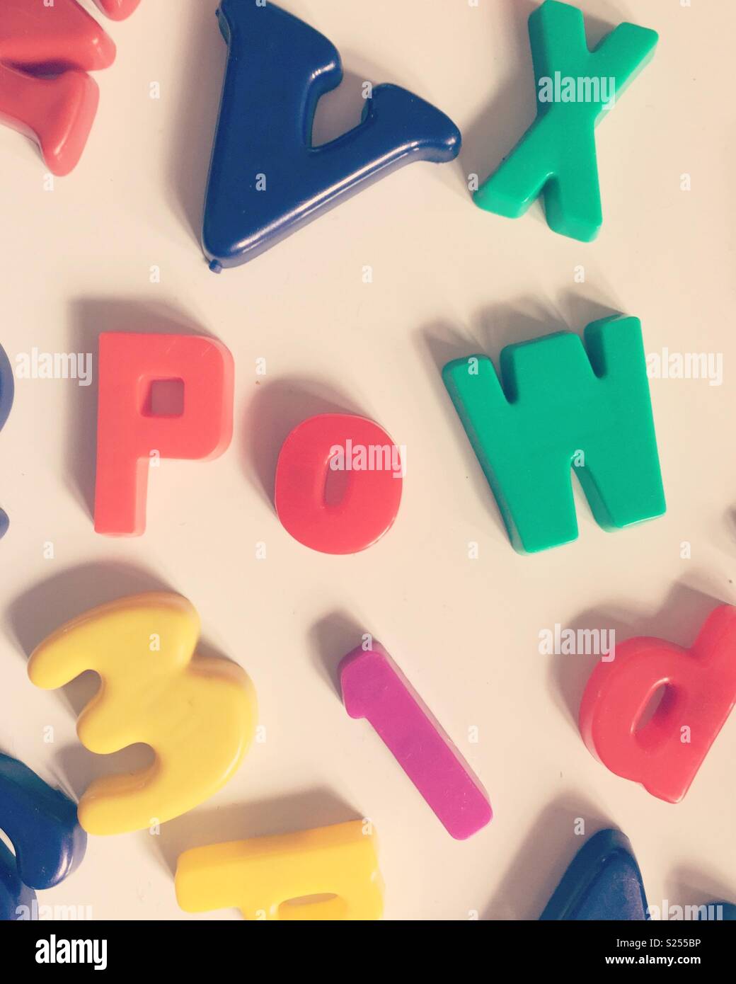 Kids colourful magnetic letters spelling out the word “pow” Stock Photo ...