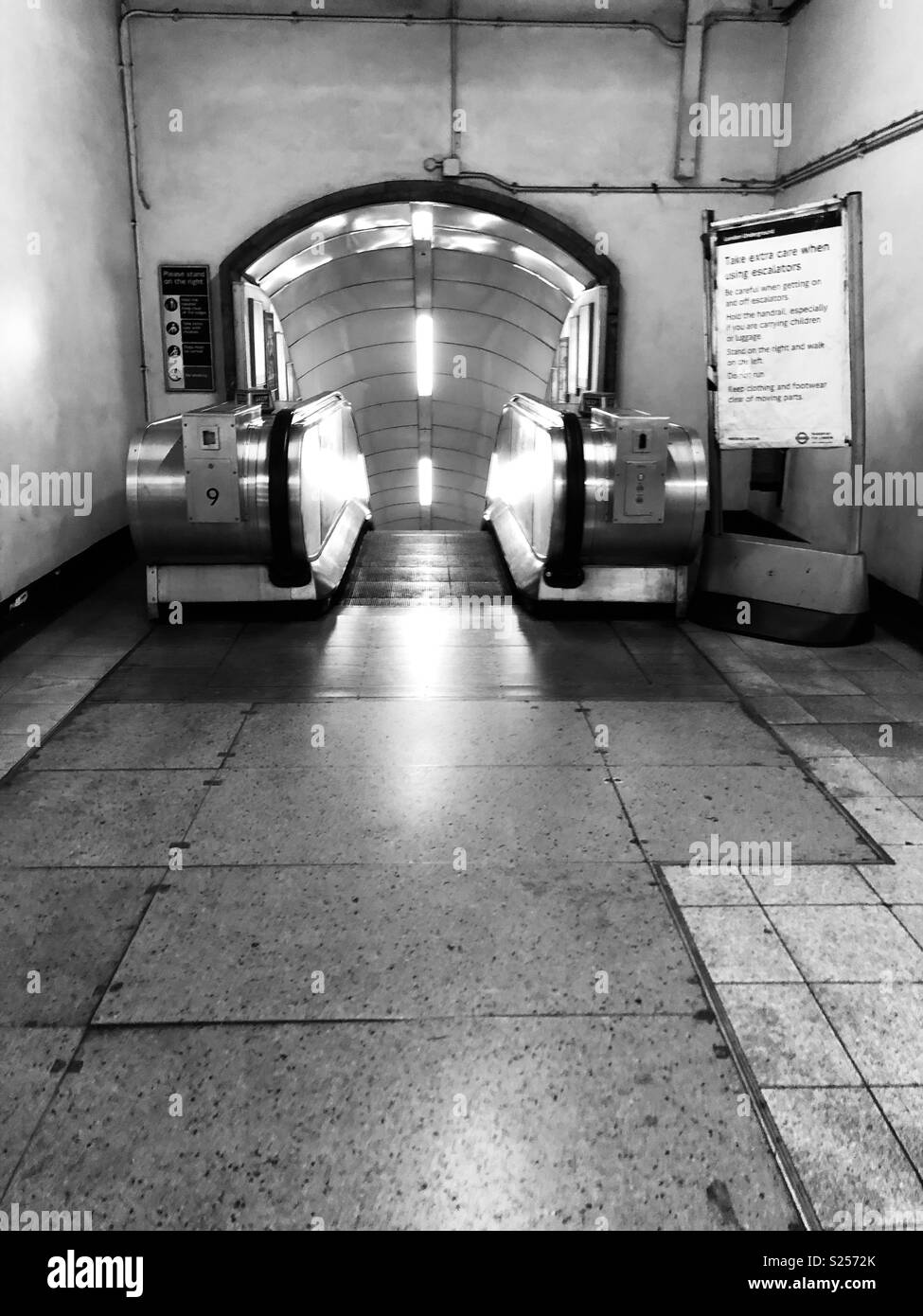 Empty tube station at the downward escalator Stock Photo - Alamy
