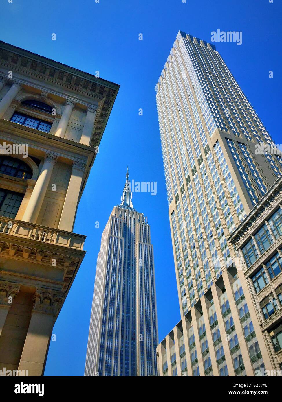 The Empire State building and Langham Hotel on fifth Avenue, NYC, USA ...