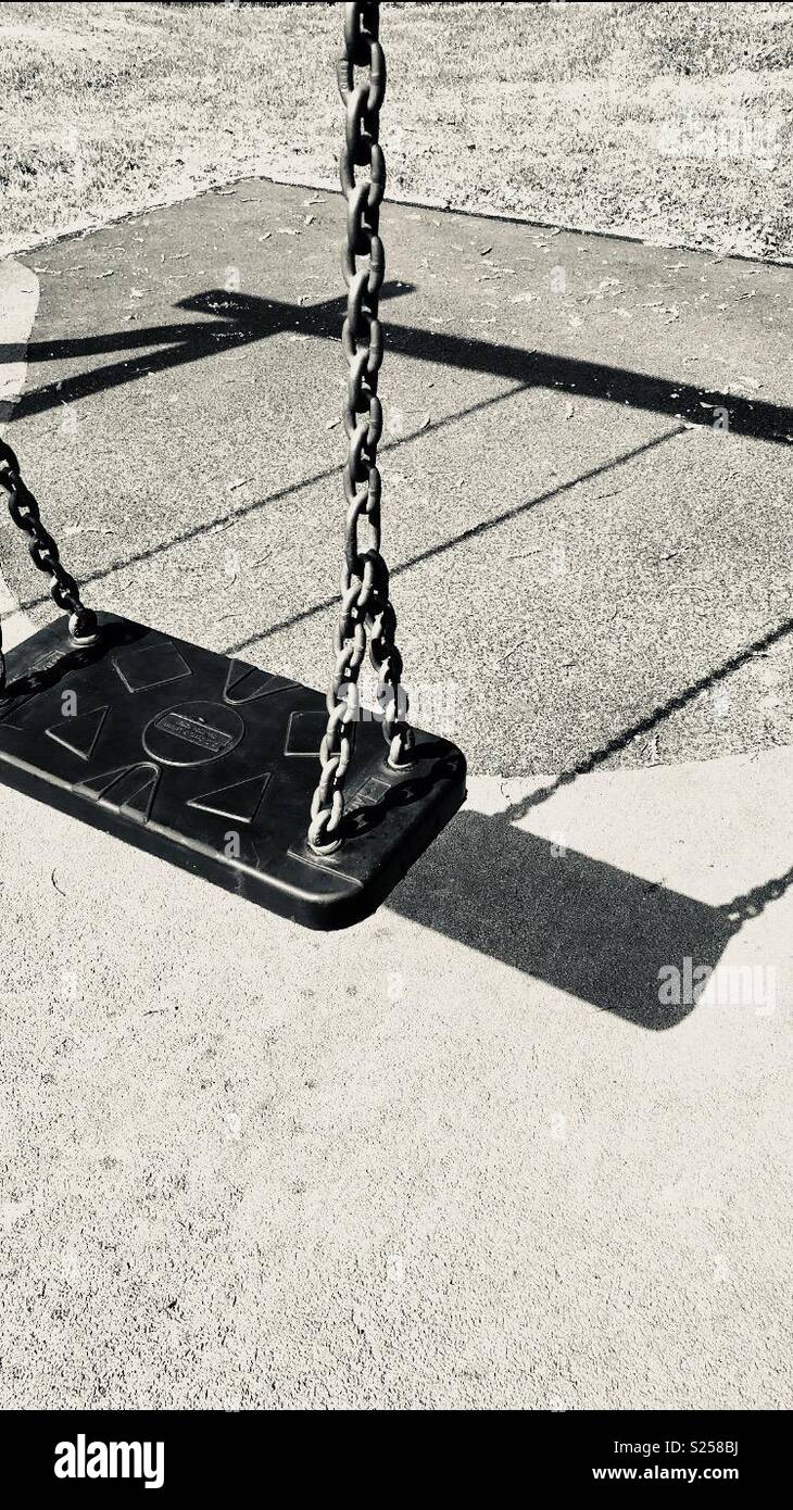 Swing with its shadow Stock Photo - Alamy