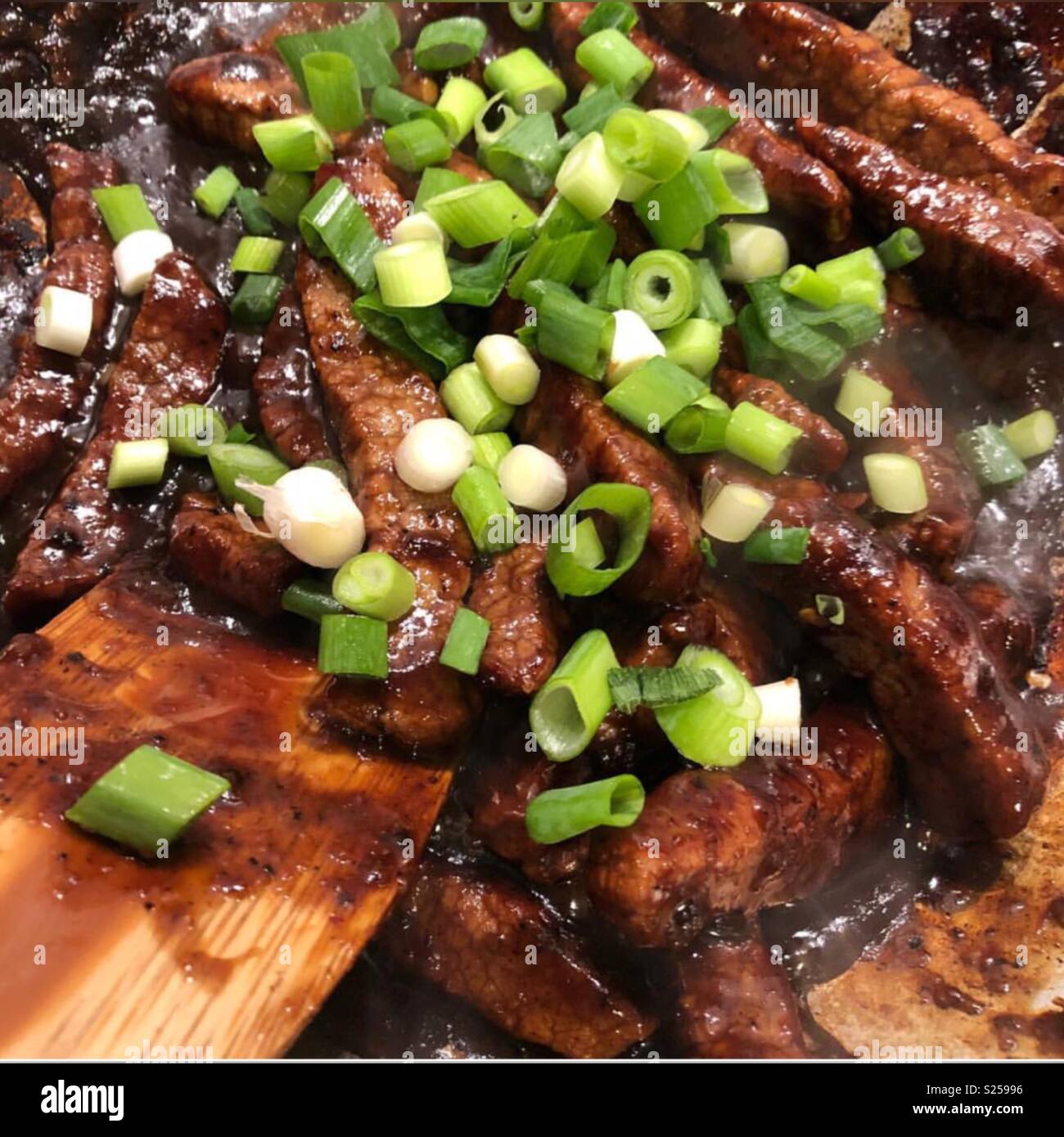 Spicy sticky beef and spring onions Stock Photo - Alamy
