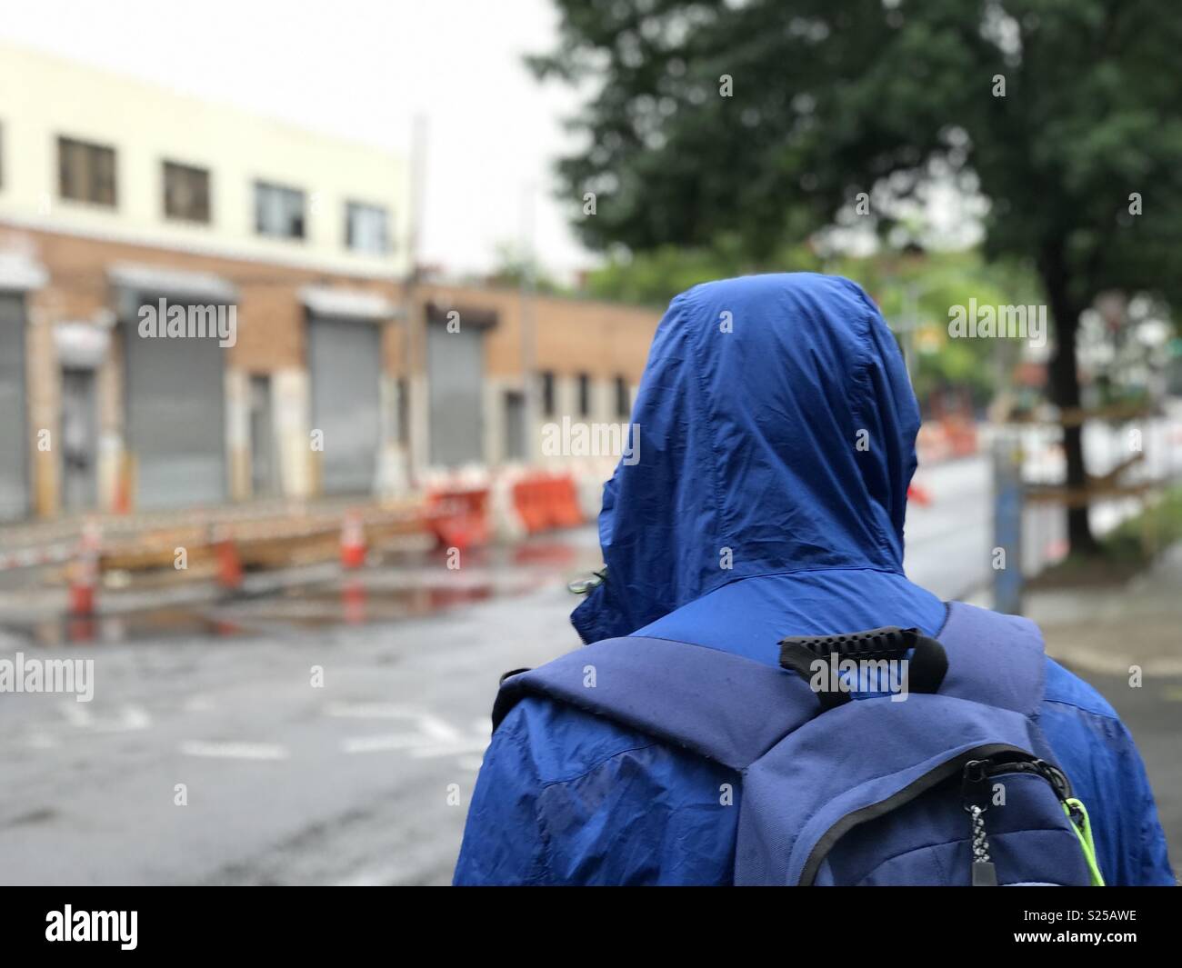 Blue raincoat hi-res stock photography and images - Alamy