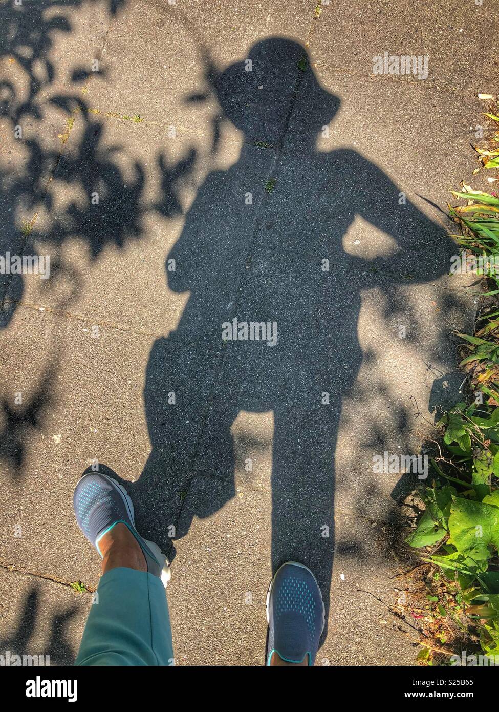 Shadow of a woman walking Stock Photo - Alamy
