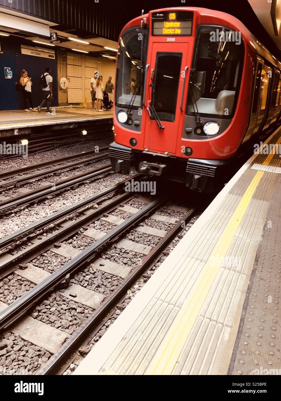 District line train pulling into a platform at Victoria Underground ...