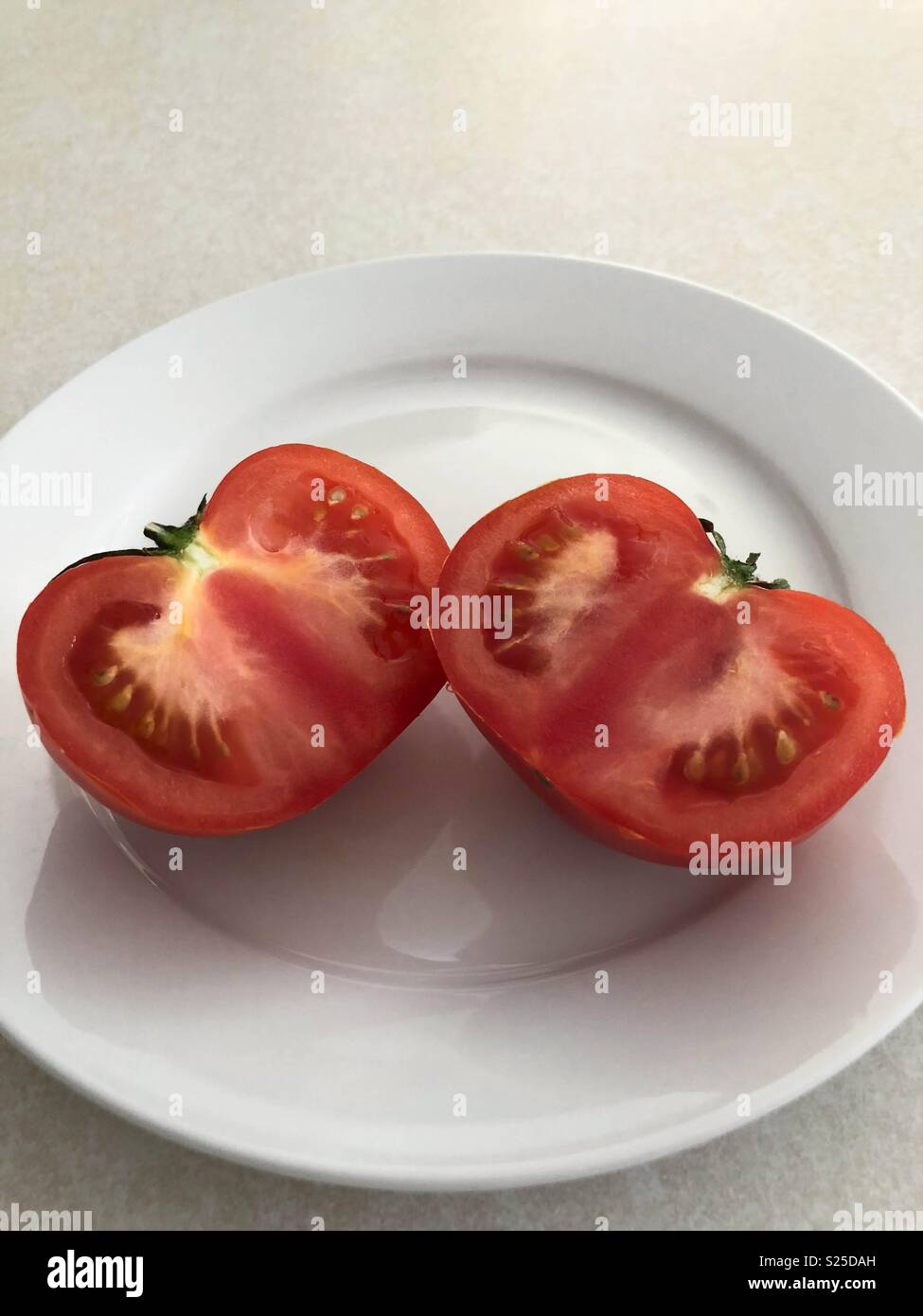 Red tomato cut in half Stock Photo - Alamy