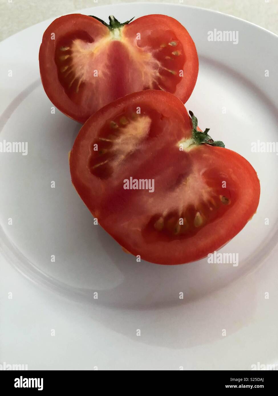 Red tomato cut in half Stock Photo - Alamy