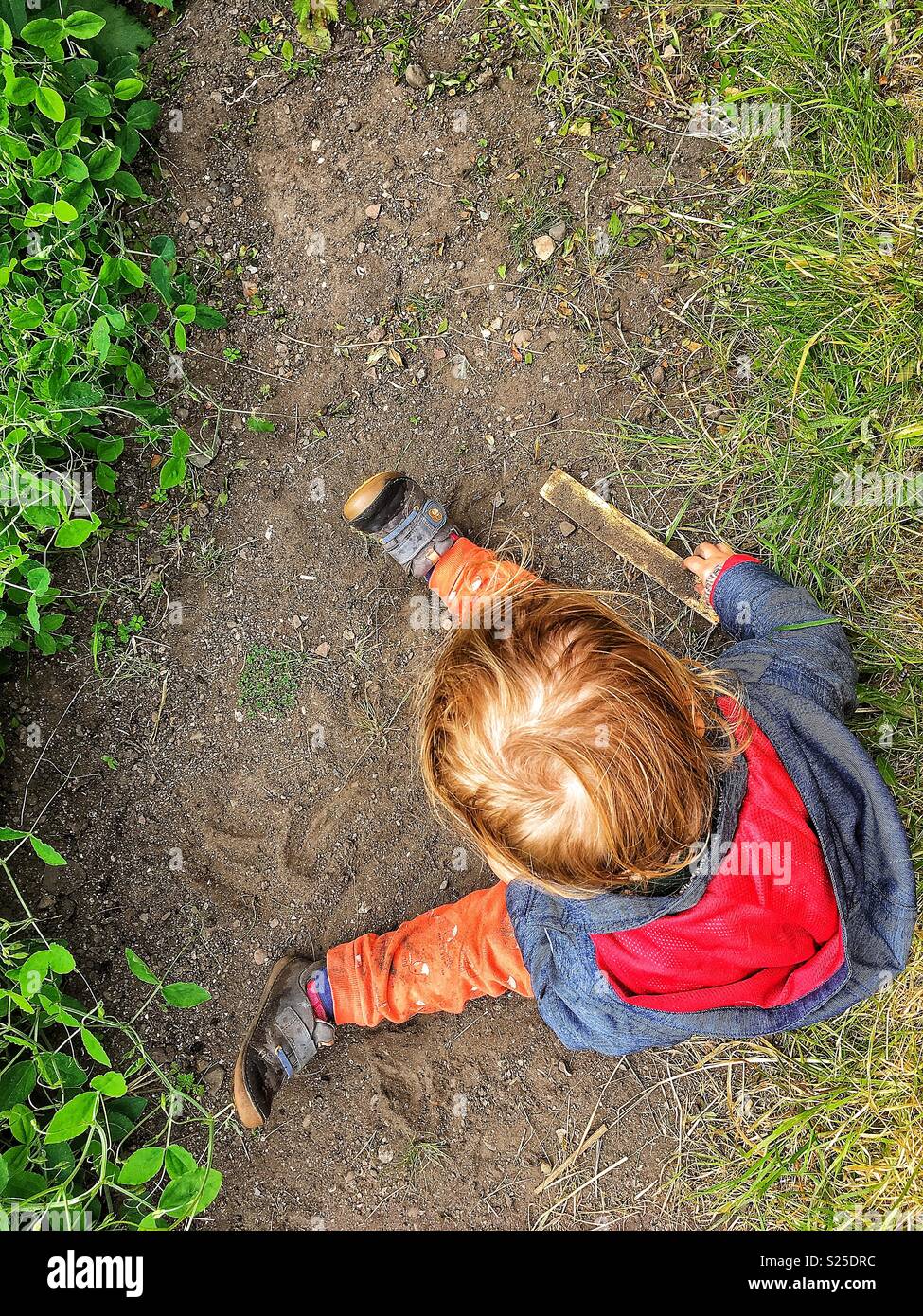 Little boy playing in dirt Stock Photo - Alamy