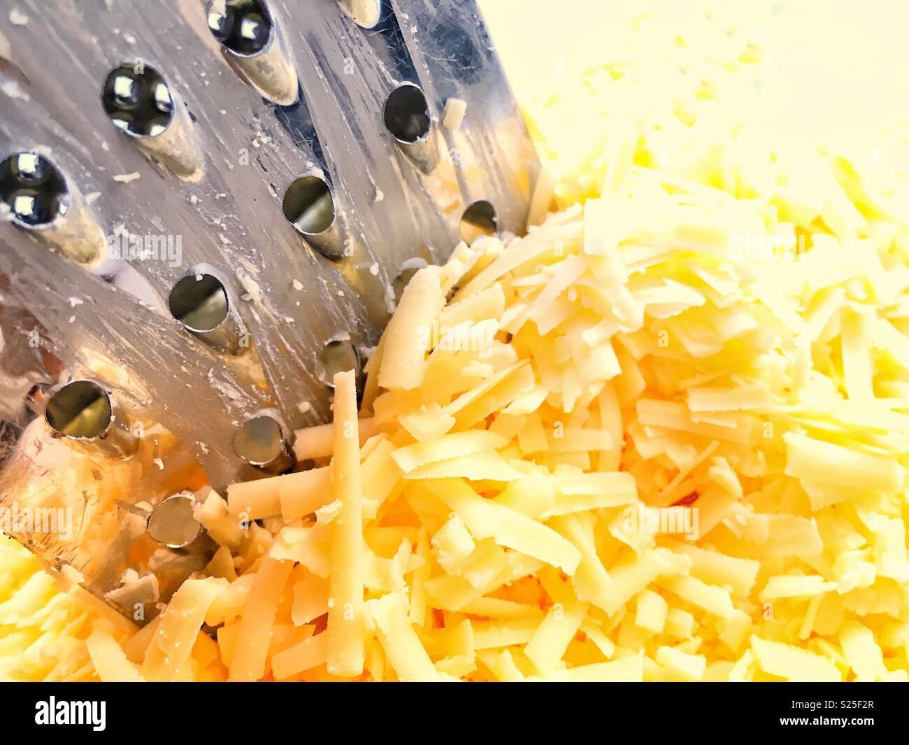 Grated cheese and grater Stock Photo - Alamy