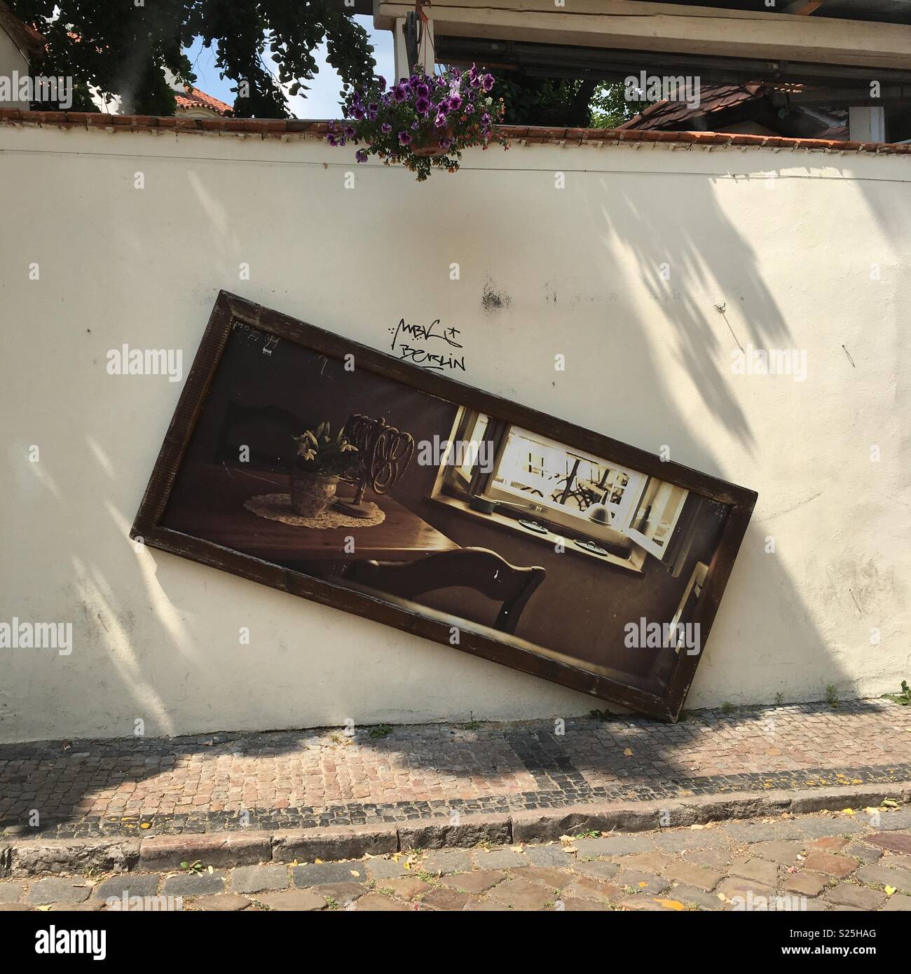 Fallen sign on wall Stock Photo - Alamy