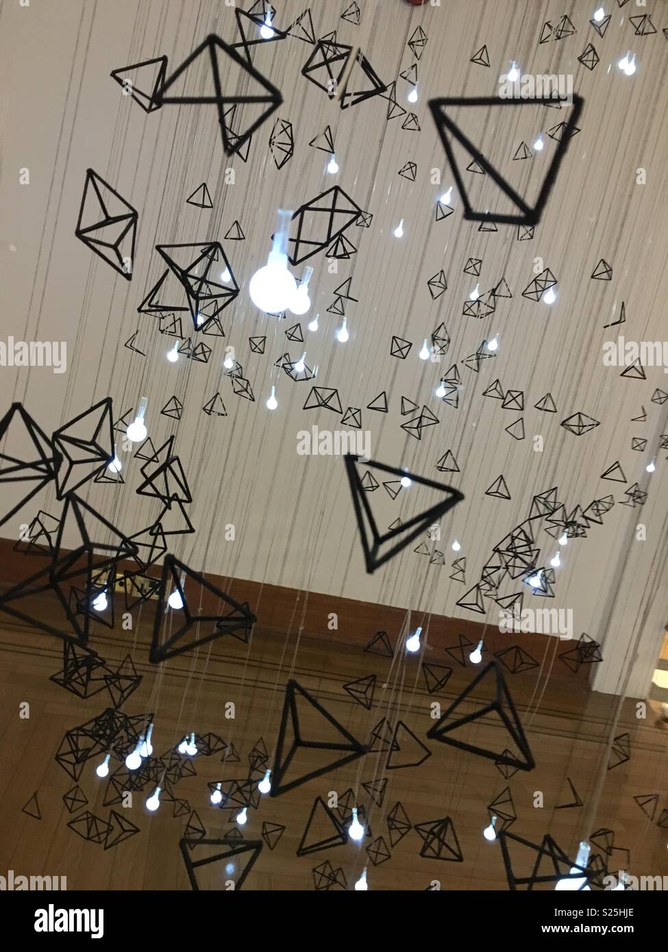 triangular lightbulb art display Stock Photo - Alamy