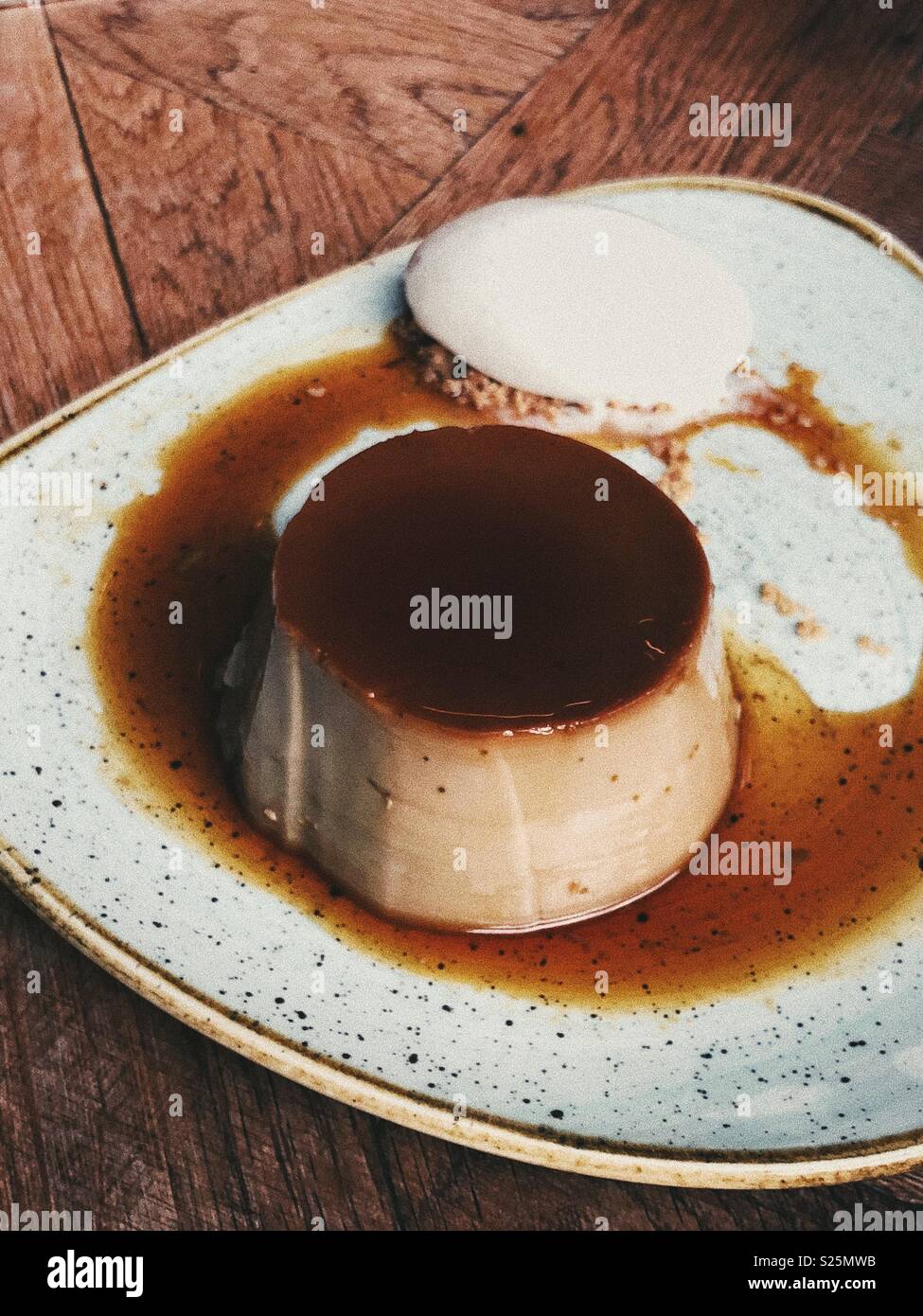 Spanish flan with ice cream on a ceramic plate Stock Photo - Alamy
