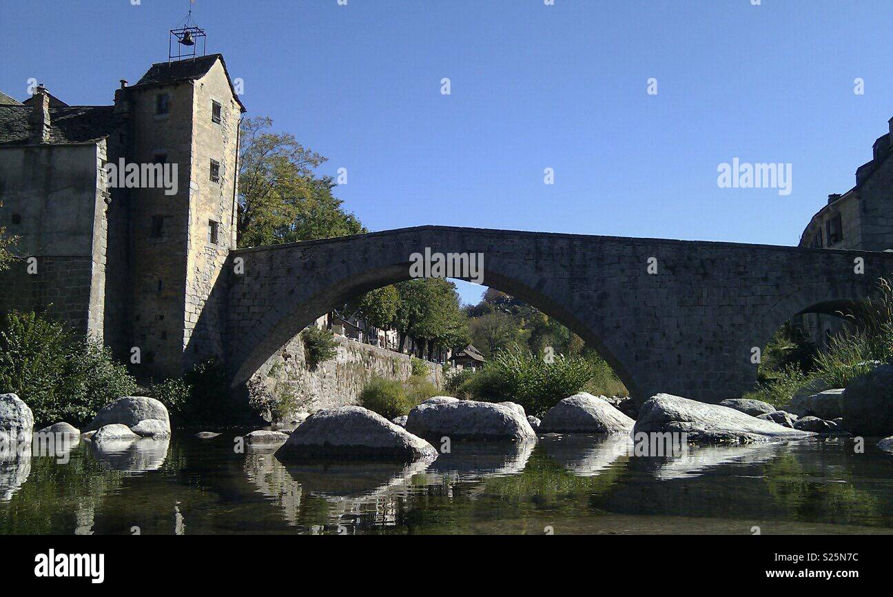 French village scene by river Stock Photo - Alamy