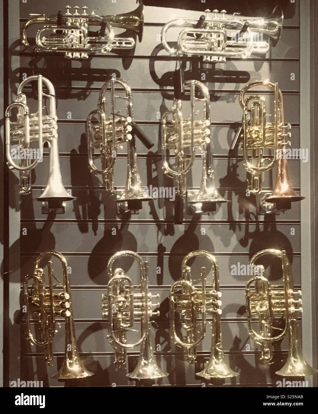 Trumpets on a wall Stock Photo - Alamy