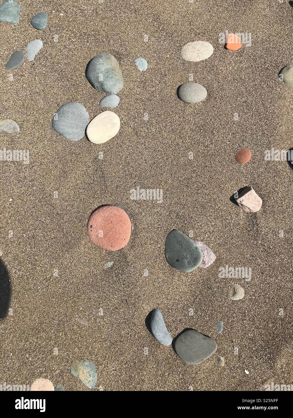 Pebbles in the sand Stock Photo - Alamy