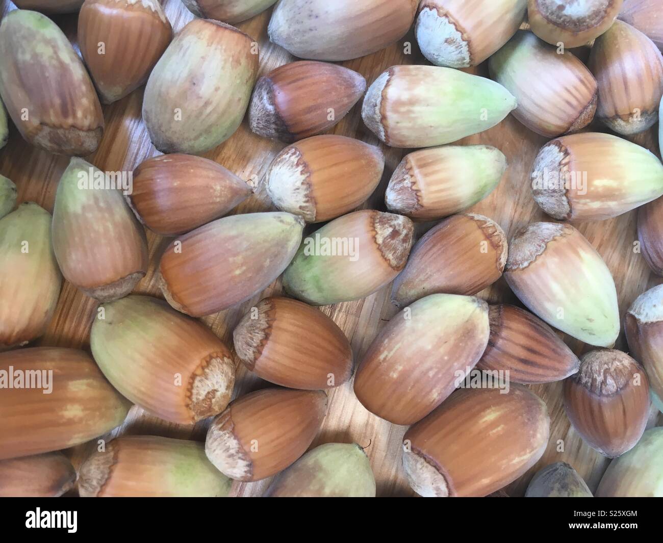 Sussex cob nuts in shell on wooden surface Stock Photo - Alamy