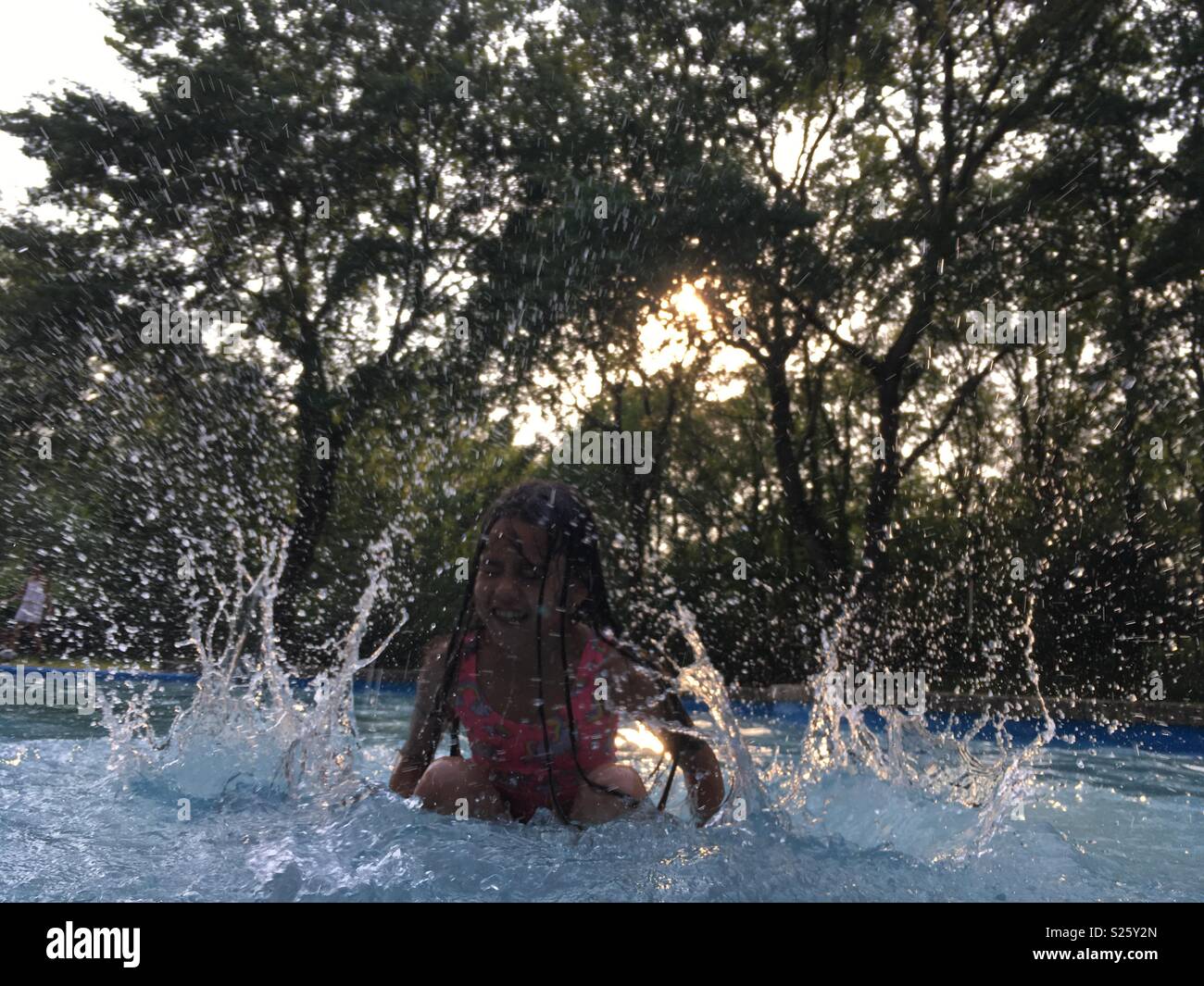 Splashing in the swimming pool hi-res stock photography and images - Alamy