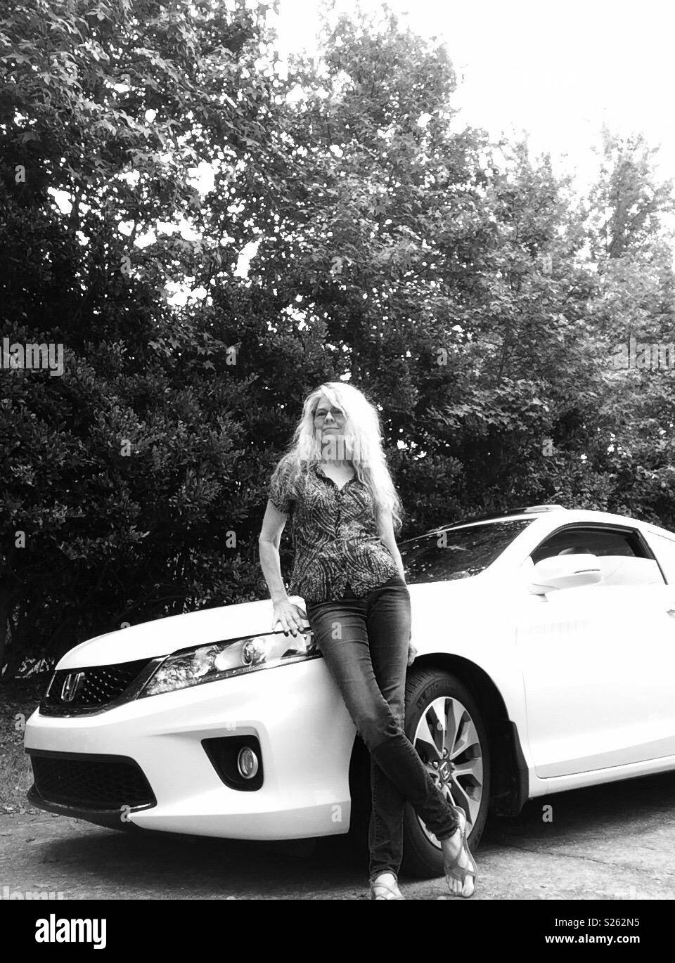 Leaning on Car Stock Photo - Alamy