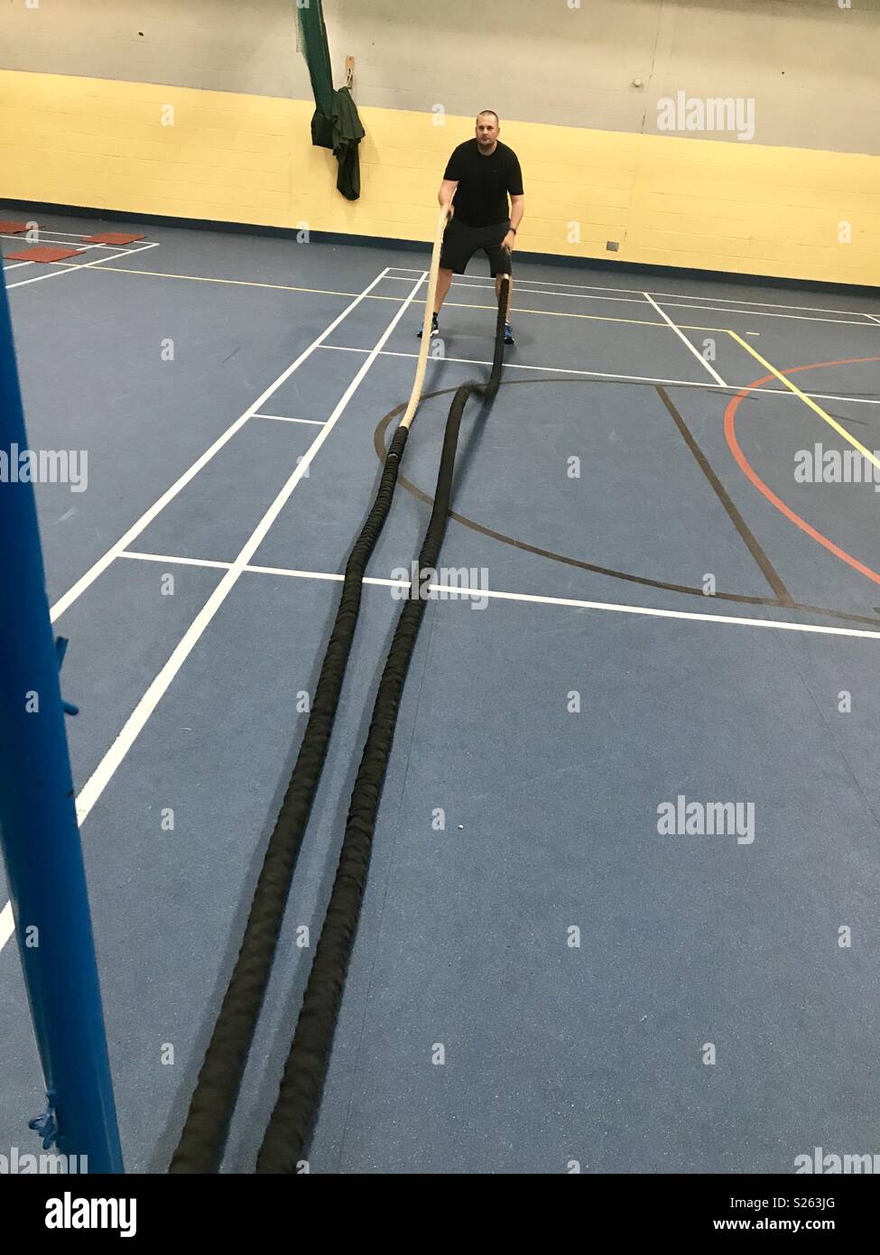 Battle ropes in the gym Stock Photo - Alamy