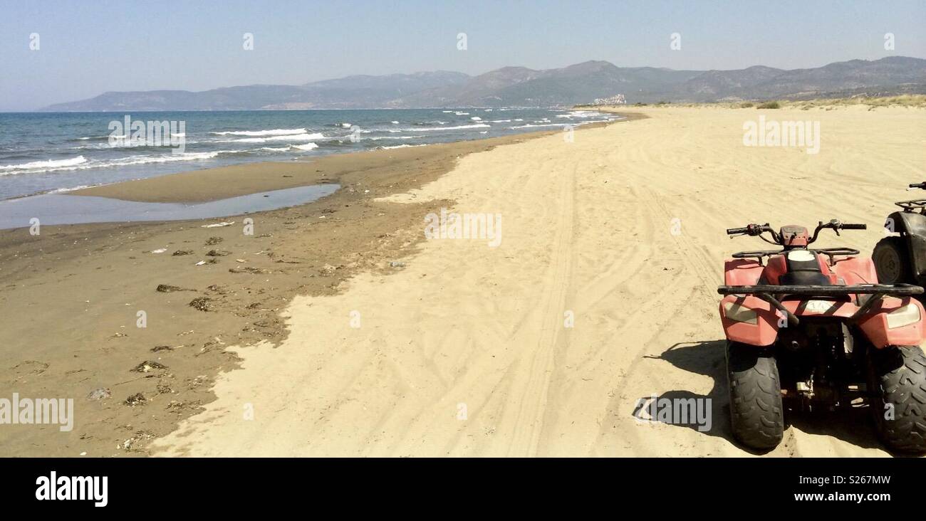 Quad biking on the beach in turkey Stock Photo - Alamy