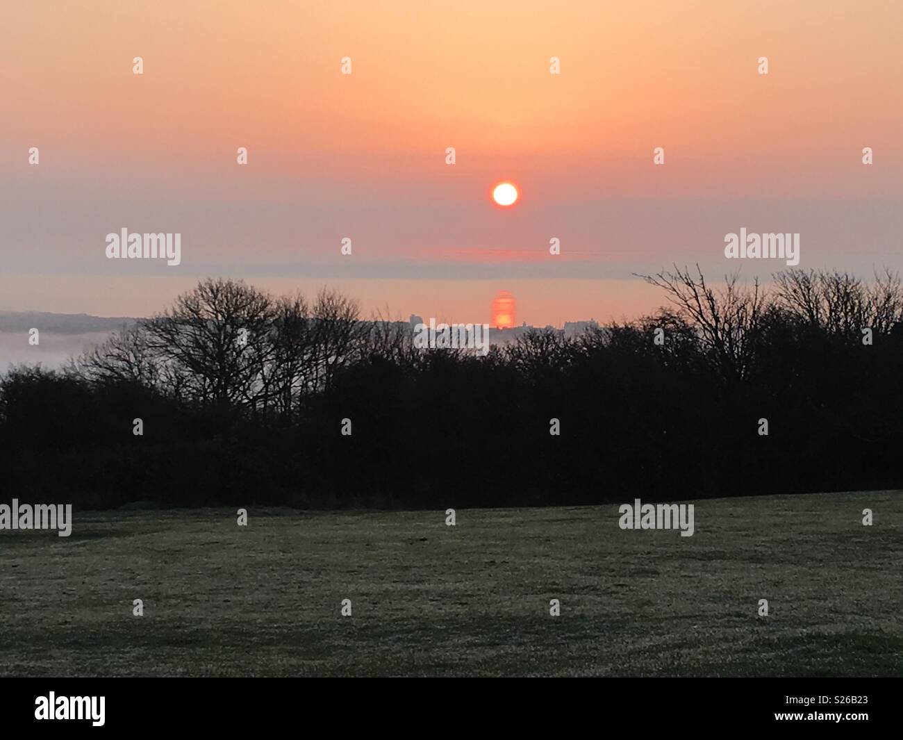 Morning sun on misty sea Stock Photo - Alamy