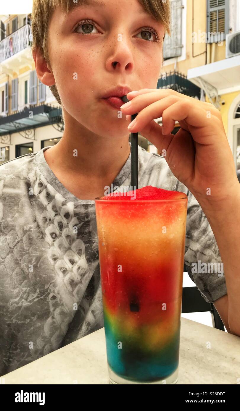 Boy drinking slush Stock Photo - Alamy